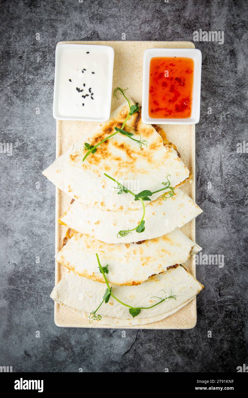 crispy flatbreads stuffed with meat, herbs, lime and two sauces, side ...