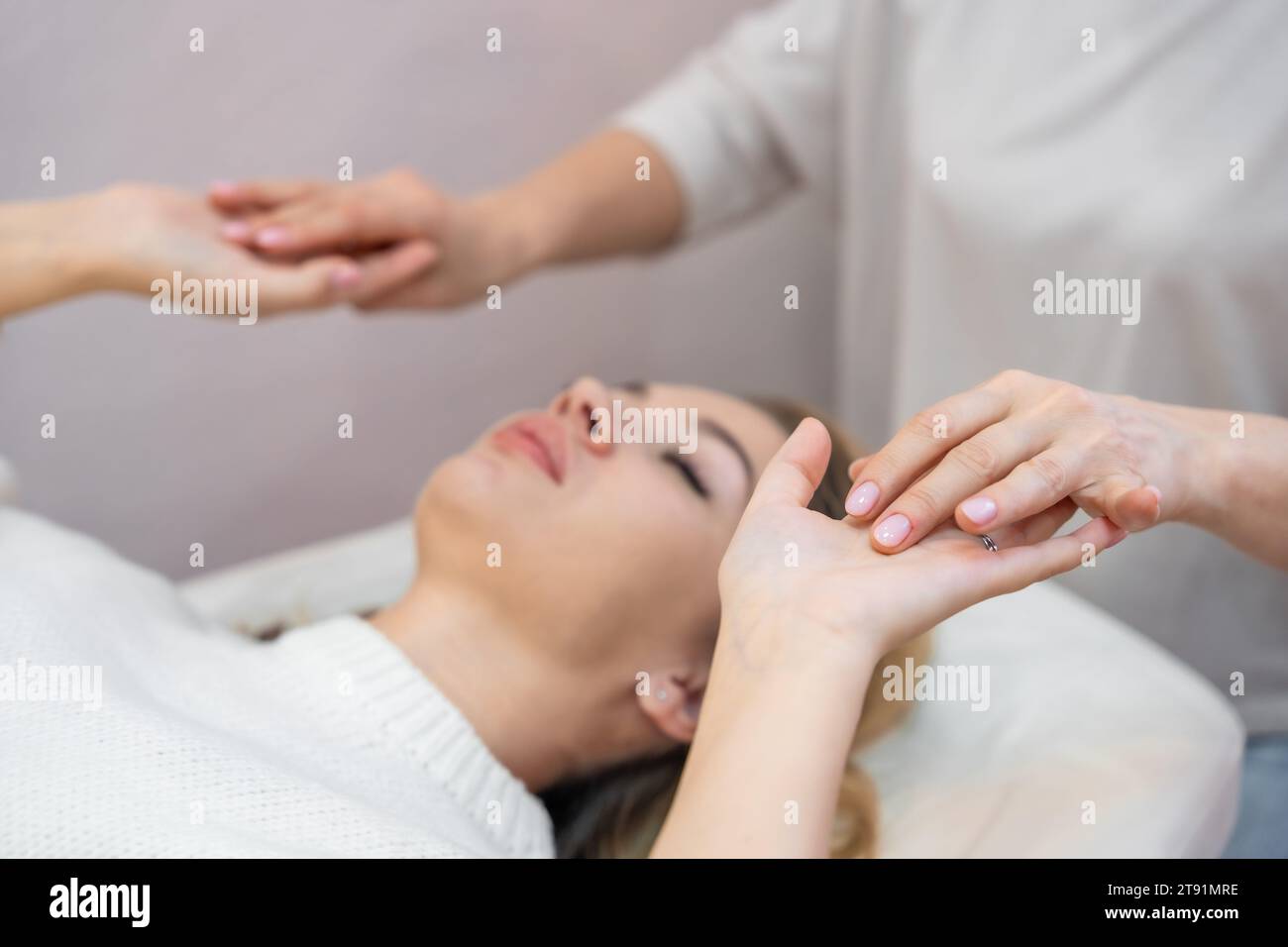 Healer launches body energy through hands before access bars therapy ...