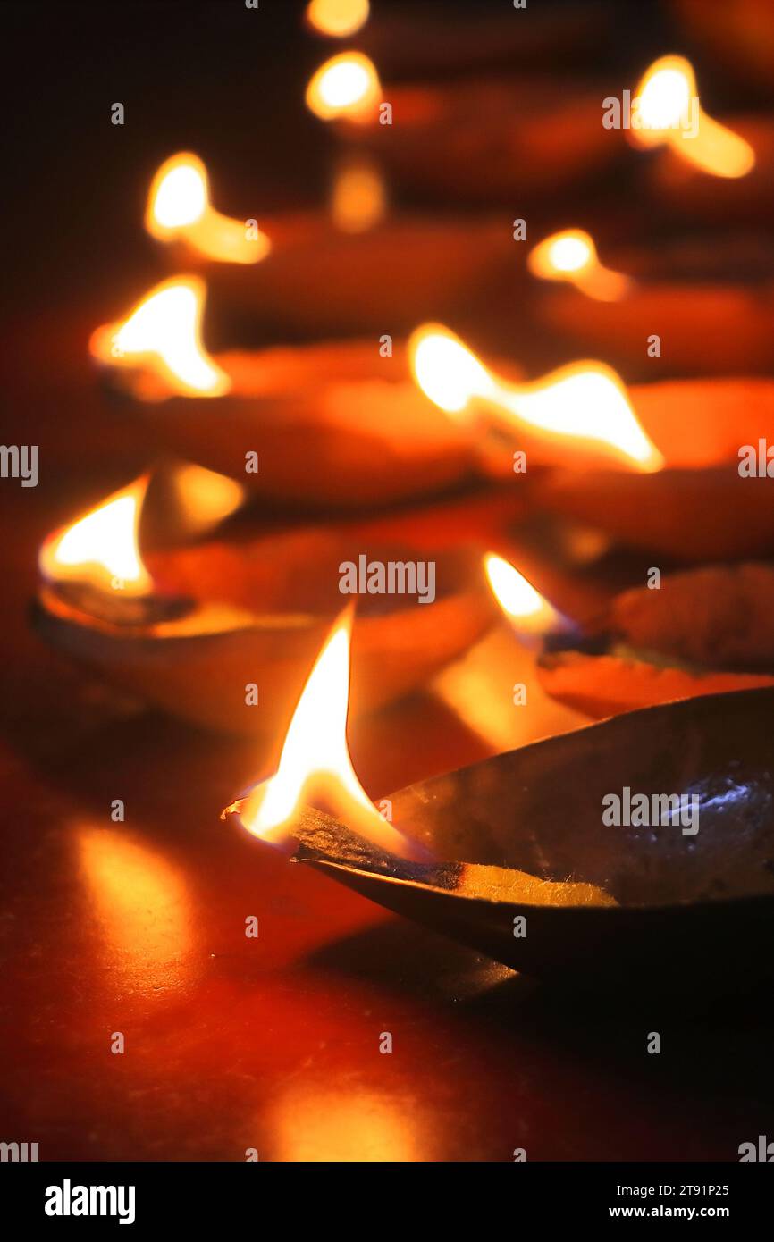 traditional oil lamps lit at the night during diwali or deepavali ...
