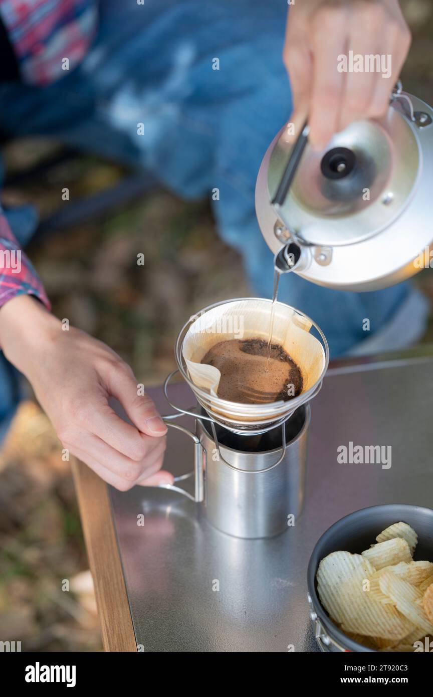A woman's hand pouring coffee Stock Photo - Alamy