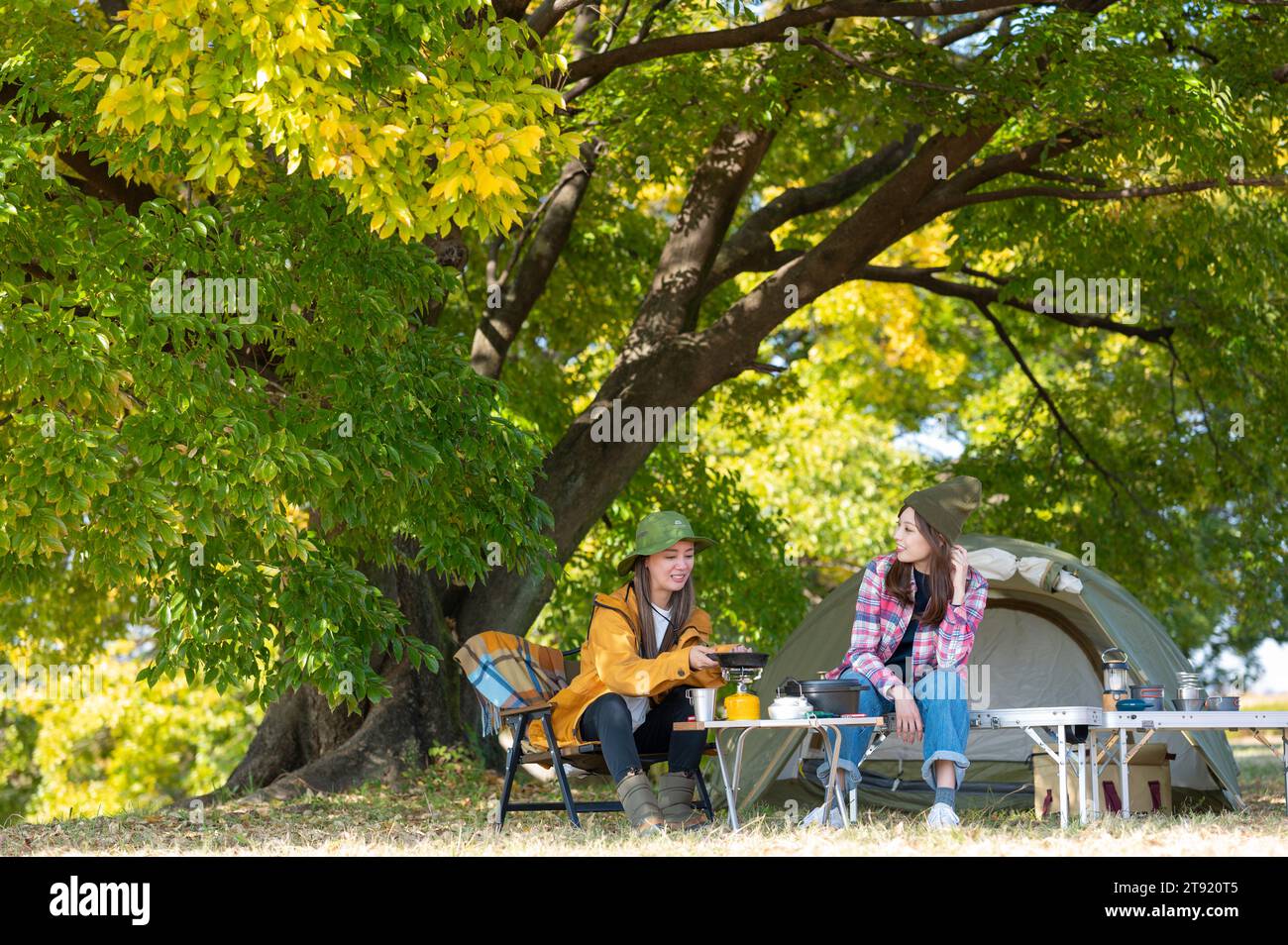 Two women enjoying camping Stock Photo - Alamy