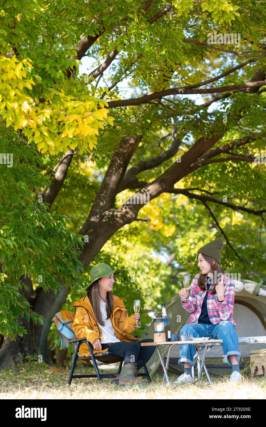 Two women enjoying camping Stock Photo - Alamy