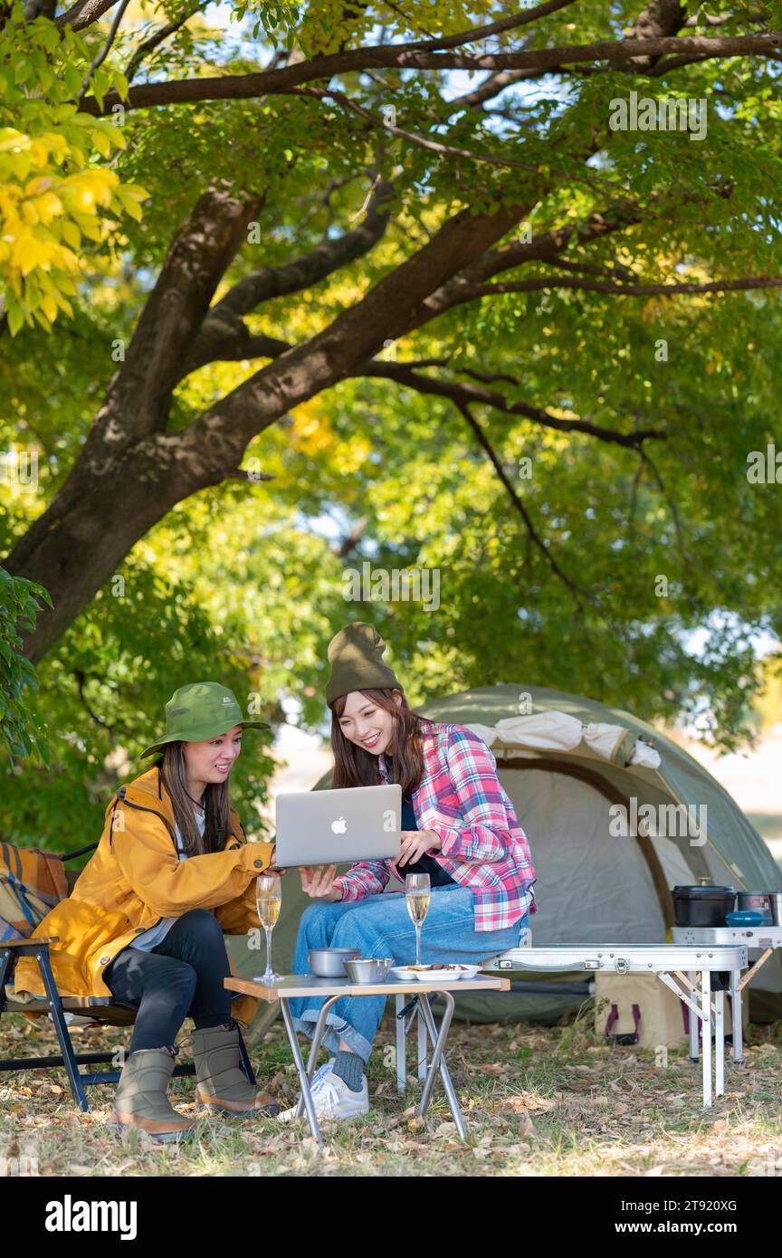 Two women enjoying camping Stock Photo - Alamy