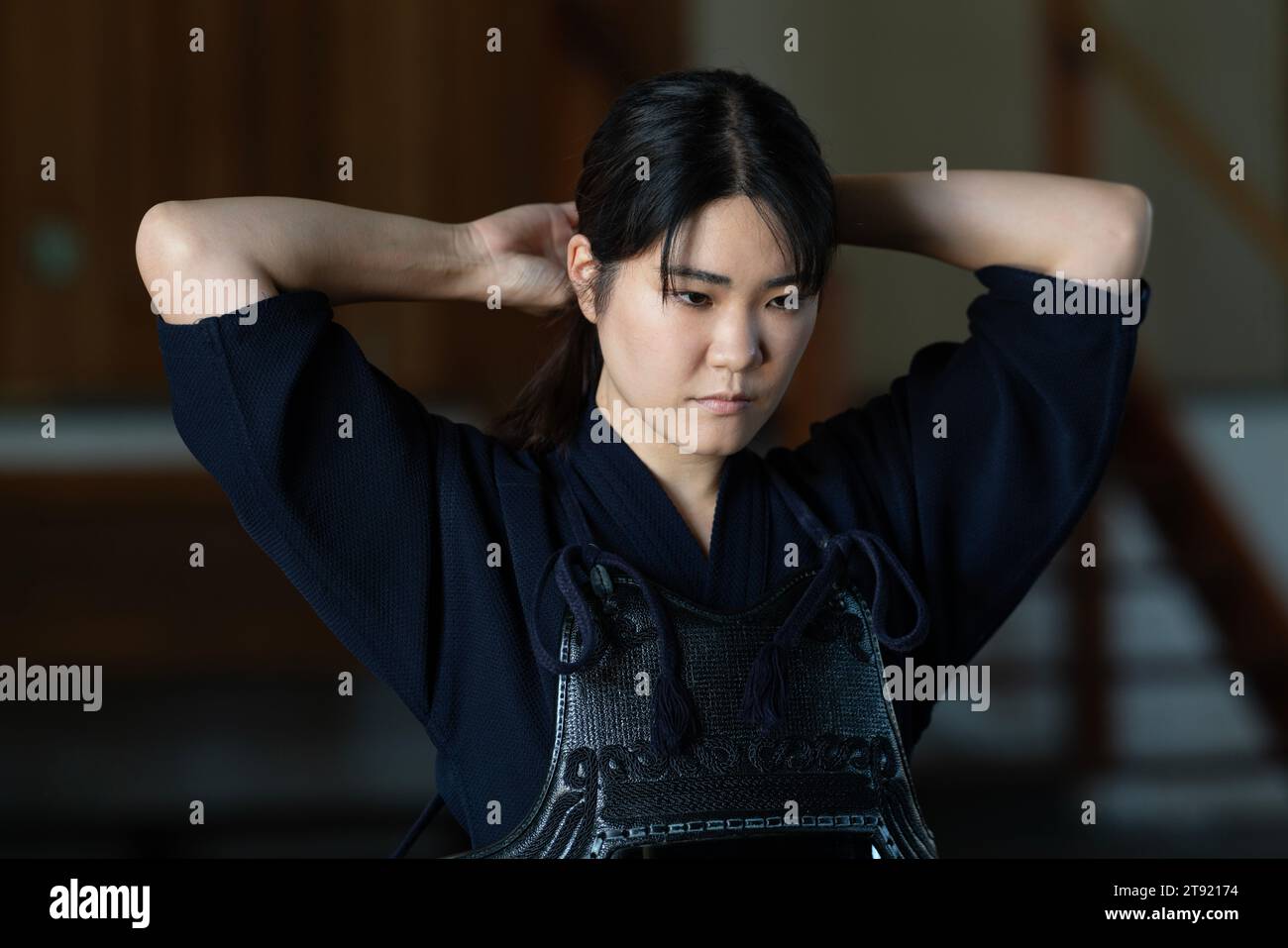 A female swordsman preparing in a kendo uniform Stock Photo - Alamy
