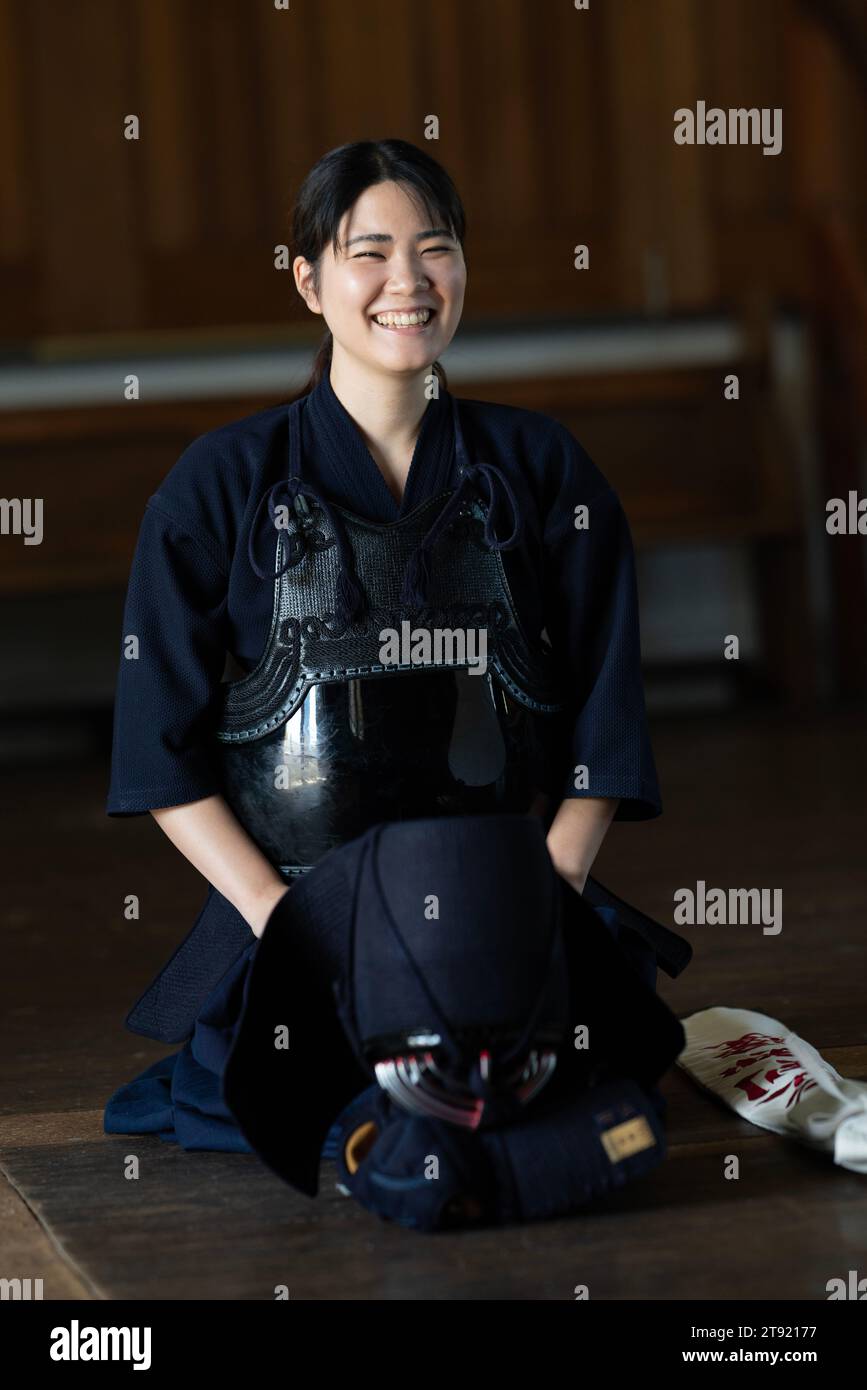 A female swordsman smiling in a kendo uniform Stock Photo - Alamy