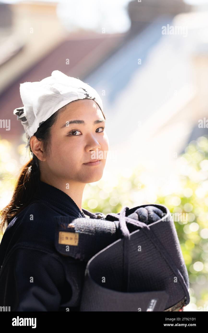 A female swordsman in a Kendo uniform holding a mask Stock Photo - Alamy