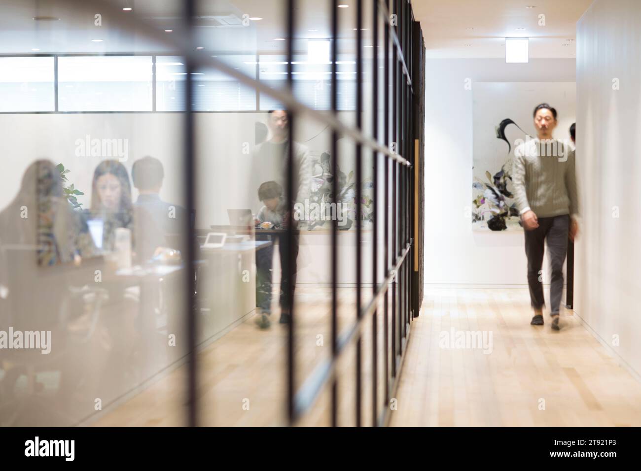 man walking down office hallway Stock Photo - Alamy