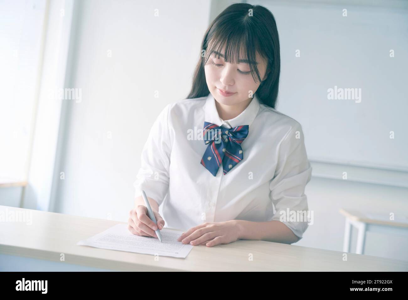 Female student writing on paper Stock Photo - Alamy