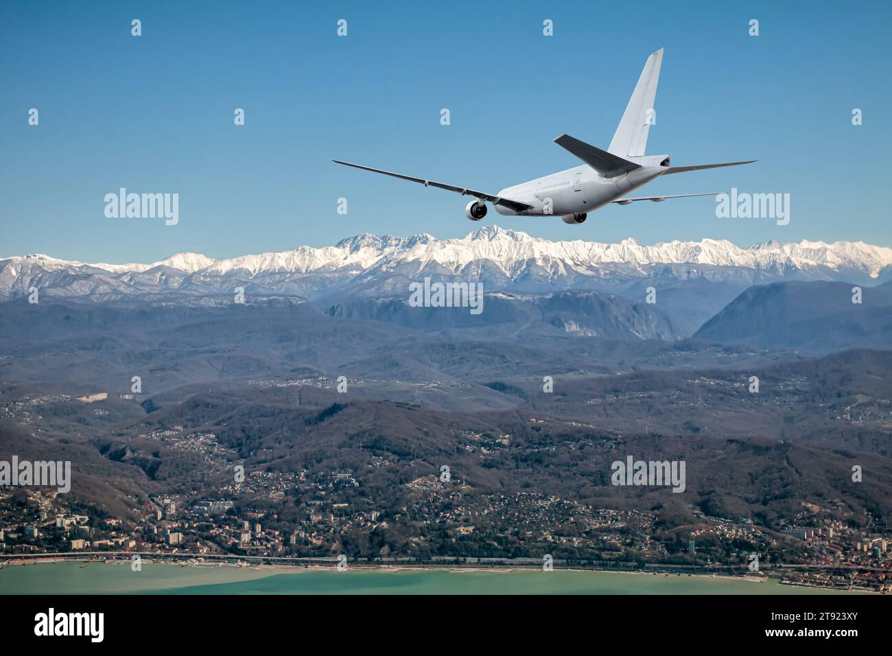 A white wide body airliner approach in a resort mountain town on the ...
