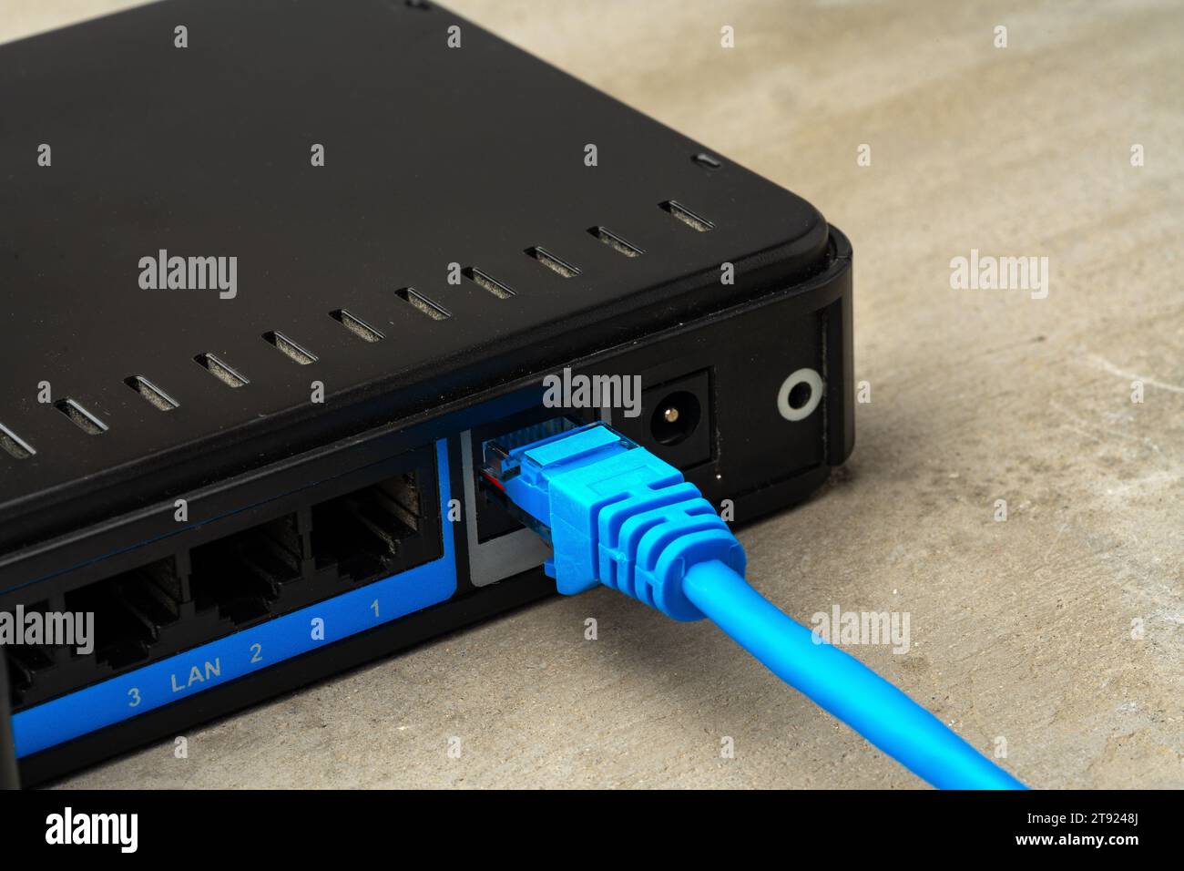 Modern router with cables plugged in close up Stock Photo - Alamy