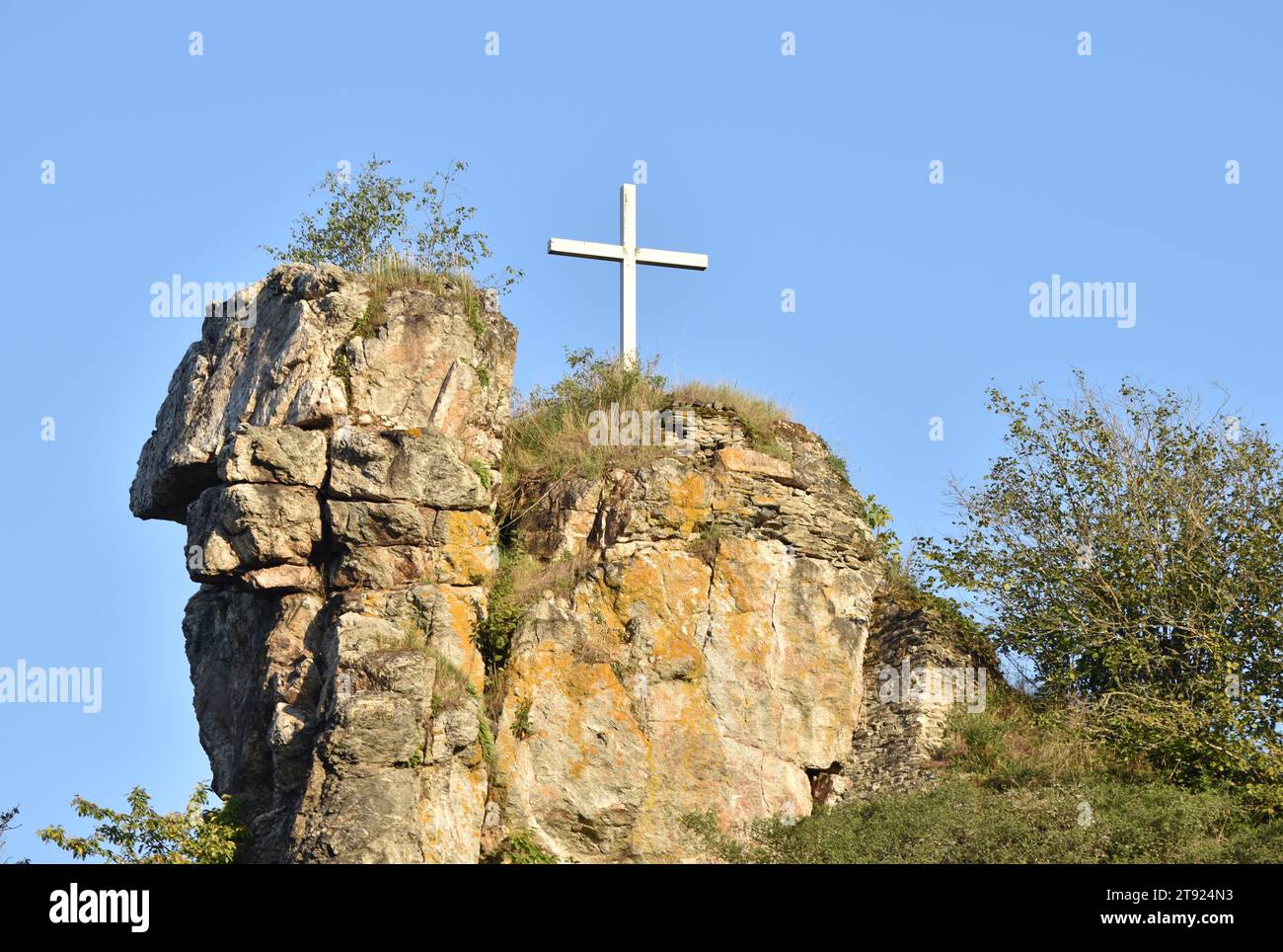 Rocky spur with summit cross on the site of the Hunolstein castle ruins ...