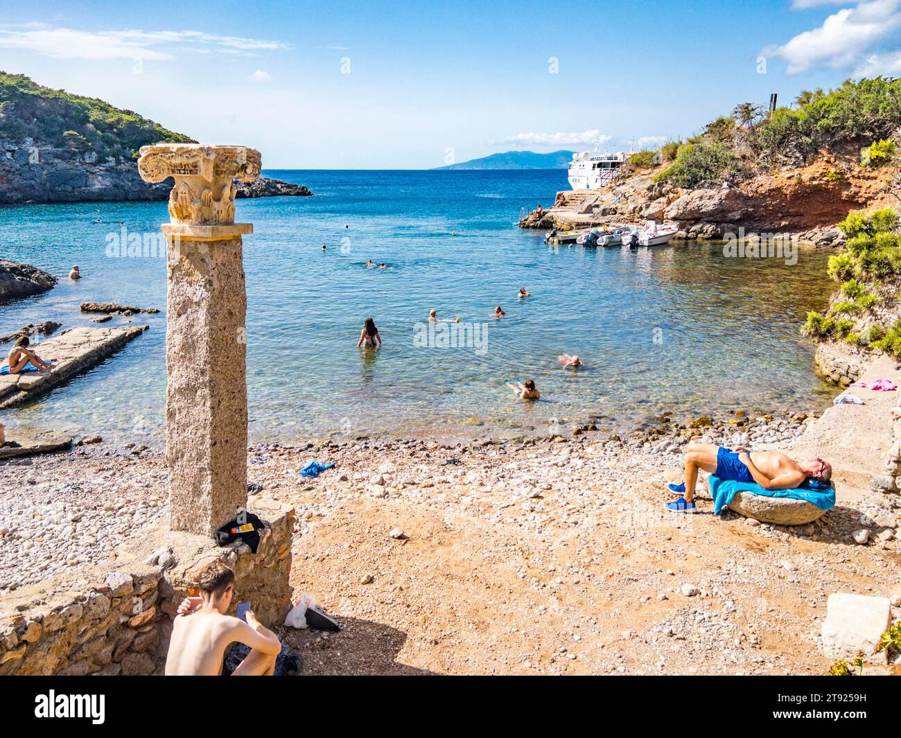 Bathers in the ancient Roman ruins of Cala Maestra, Giannutri Island ...
