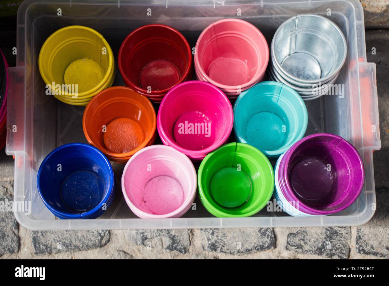 Little set of buckets of various colors in a market place Stock Photo ...
