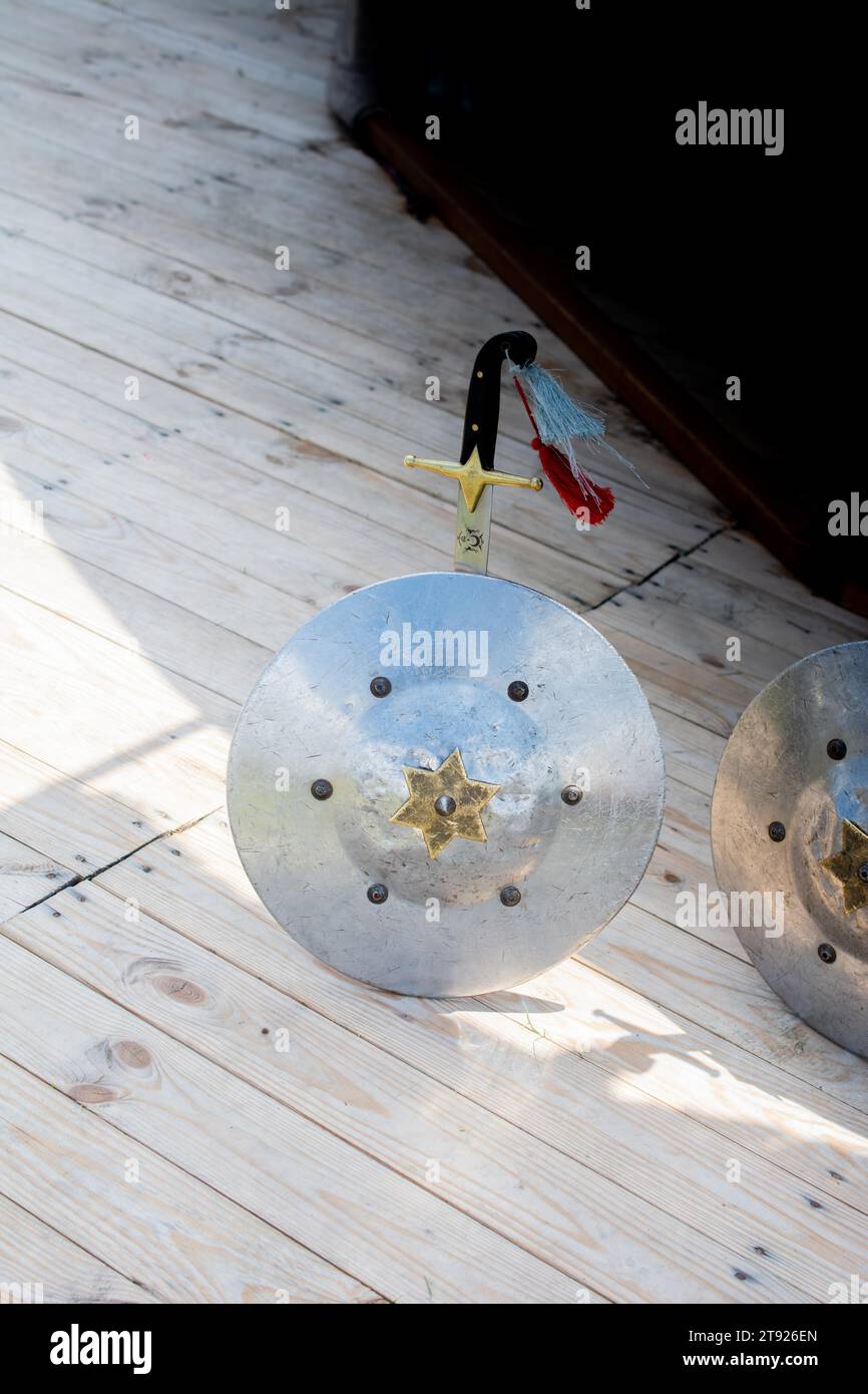 Shiny steel shields and knives in the view Stock Photo - Alamy