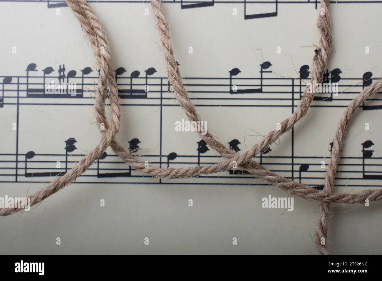 Linen thread is placed on paper with musical notes Stock Photo - Alamy