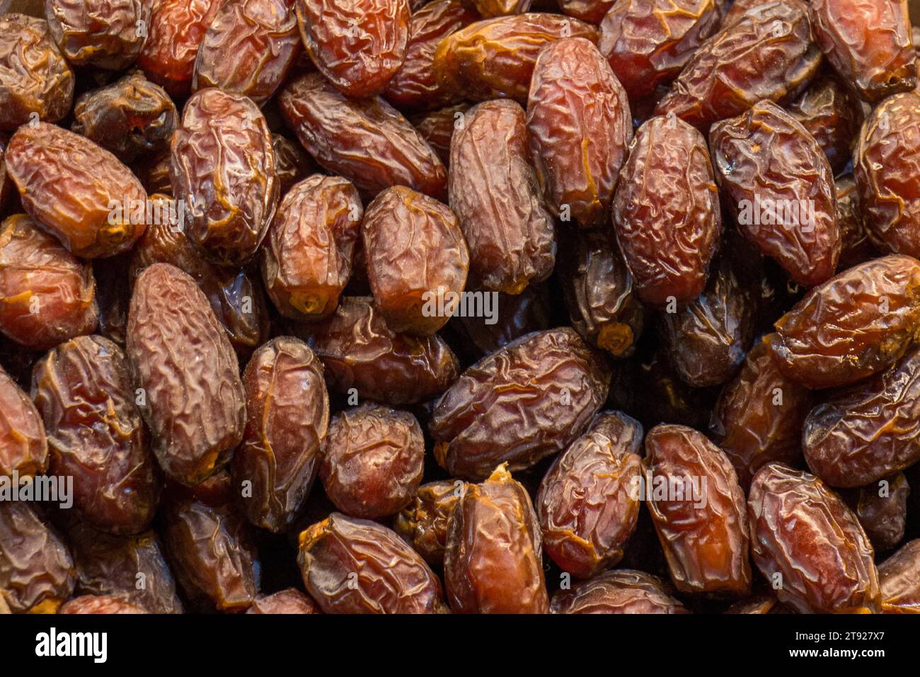 Hand holding dates on a linen canvas background Stock Photo - Alamy