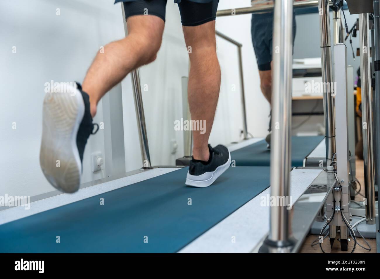 Legs of a patient performing a cardiovascular stress test walking on a ...