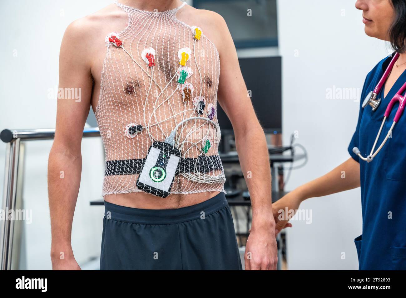 Cardiologist attaching a Ecg Holter to a patient to perform a ...