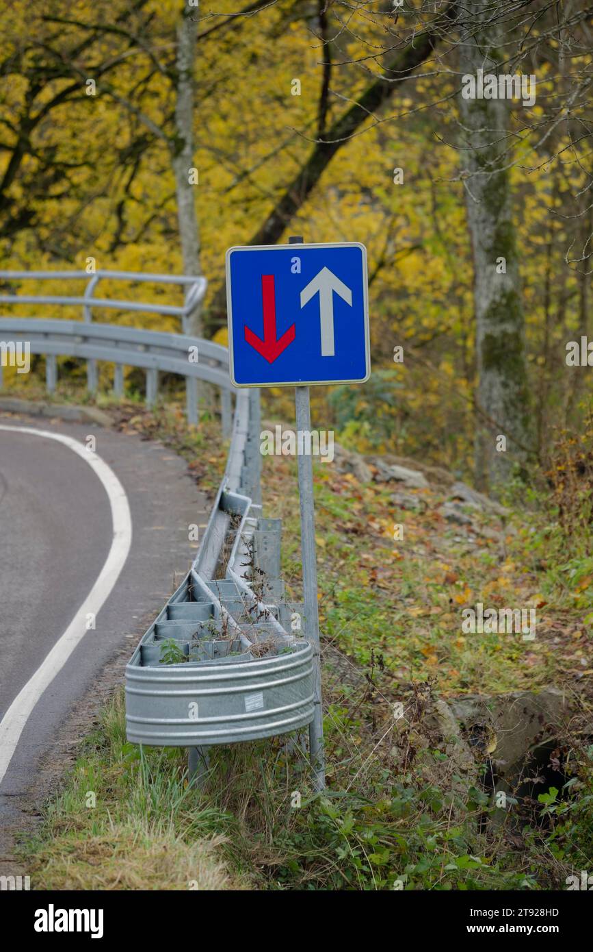 Signs with traffic rules to give way on bridge with narrow road width ...