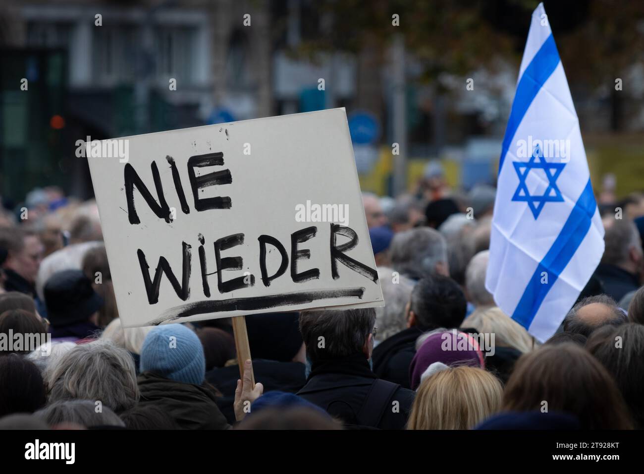 NEVER AGAIN is written on a placard. Under the motto Never again is now ...