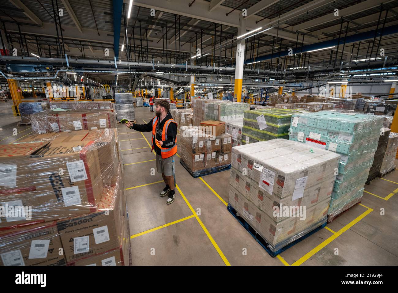 A worker scans barcodes on inbound stock items at Amazon's fulfillment ...