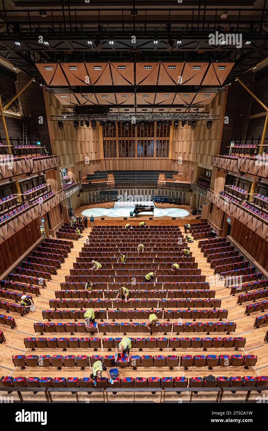 Staff clean a section of 2100 seats, designed by Rana Begum, inside ...