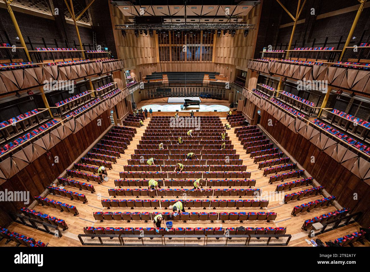 Staff clean a section of 2100 seats, designed by Rana Begum, inside ...