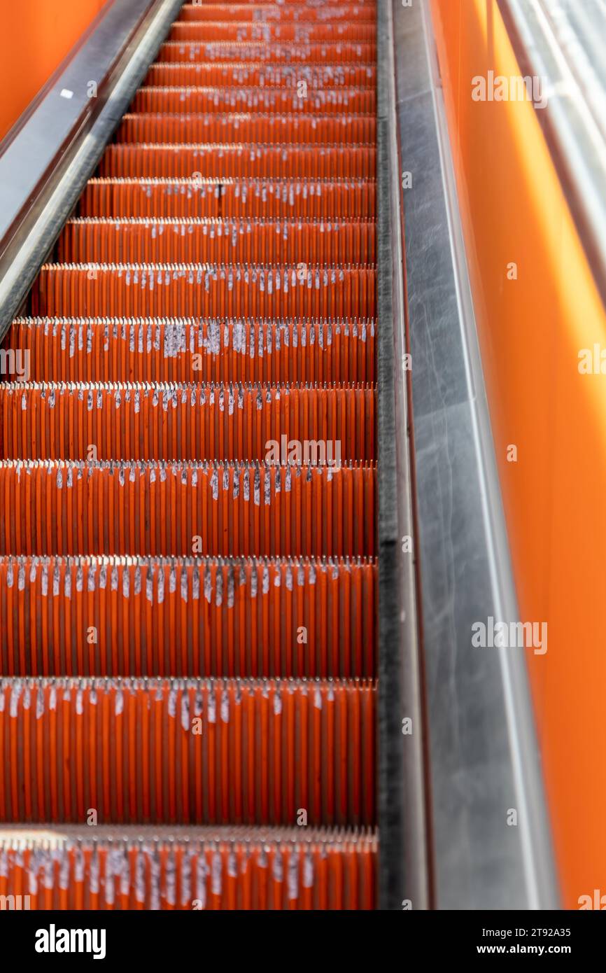 Details of an escalator with aged stairs in red and orange Stock Photo ...
