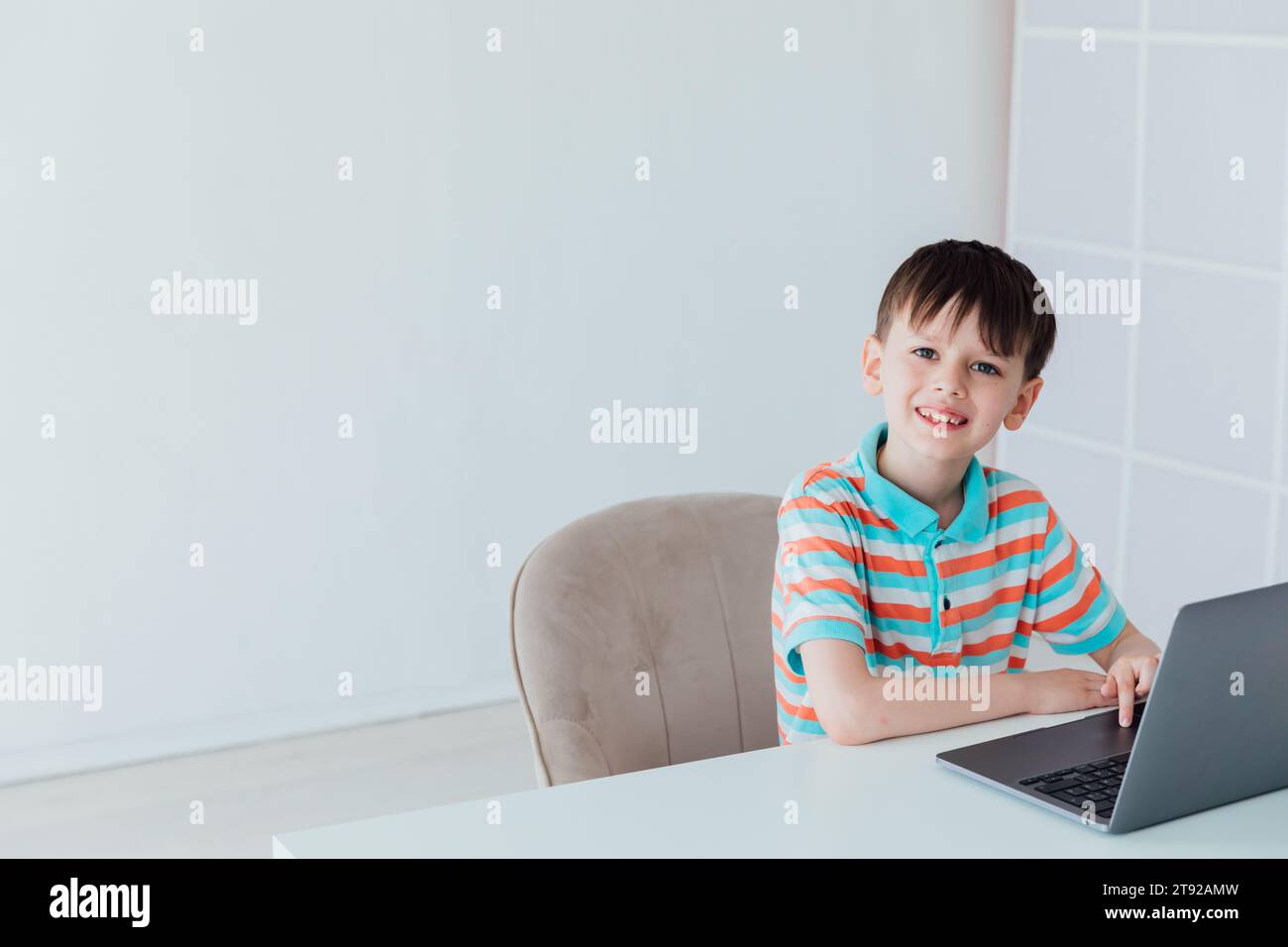 Boy doing learning task at school on computer Stock Photo - Alamy