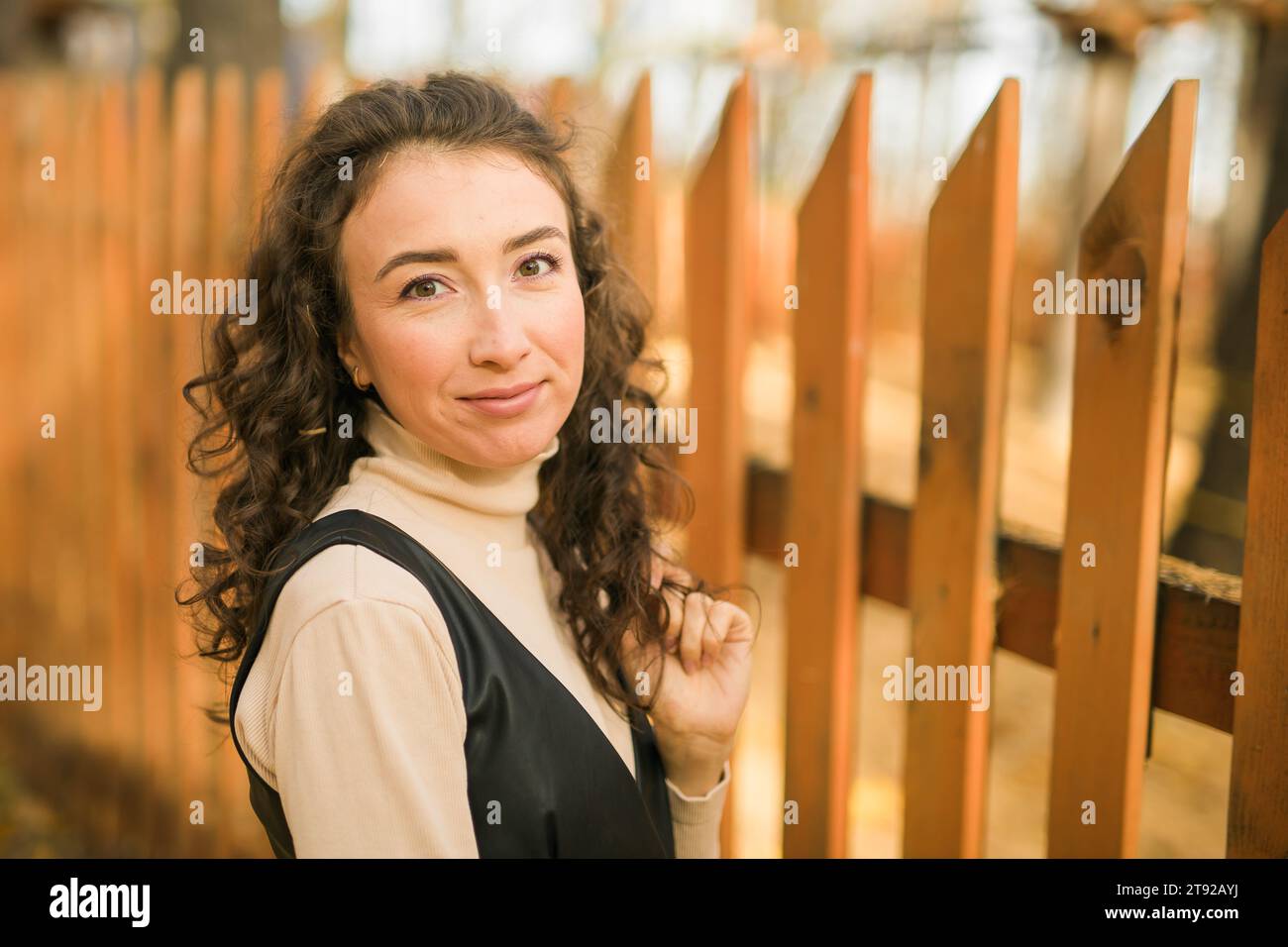 Autumn portrait of a beautiful happy curly woman in fall season copy ...