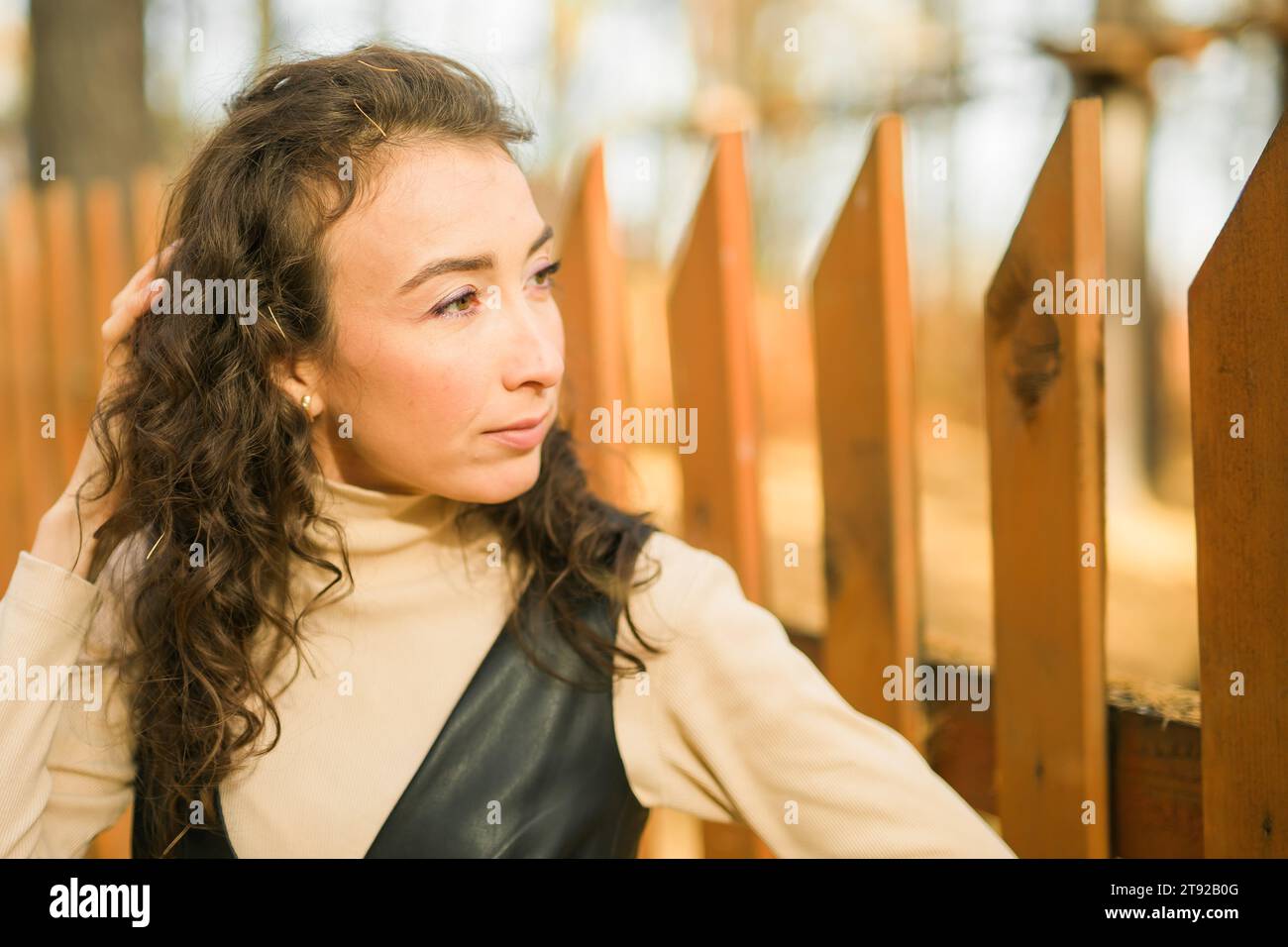 Autumn portrait of a beautiful happy curly woman in fall season copy ...