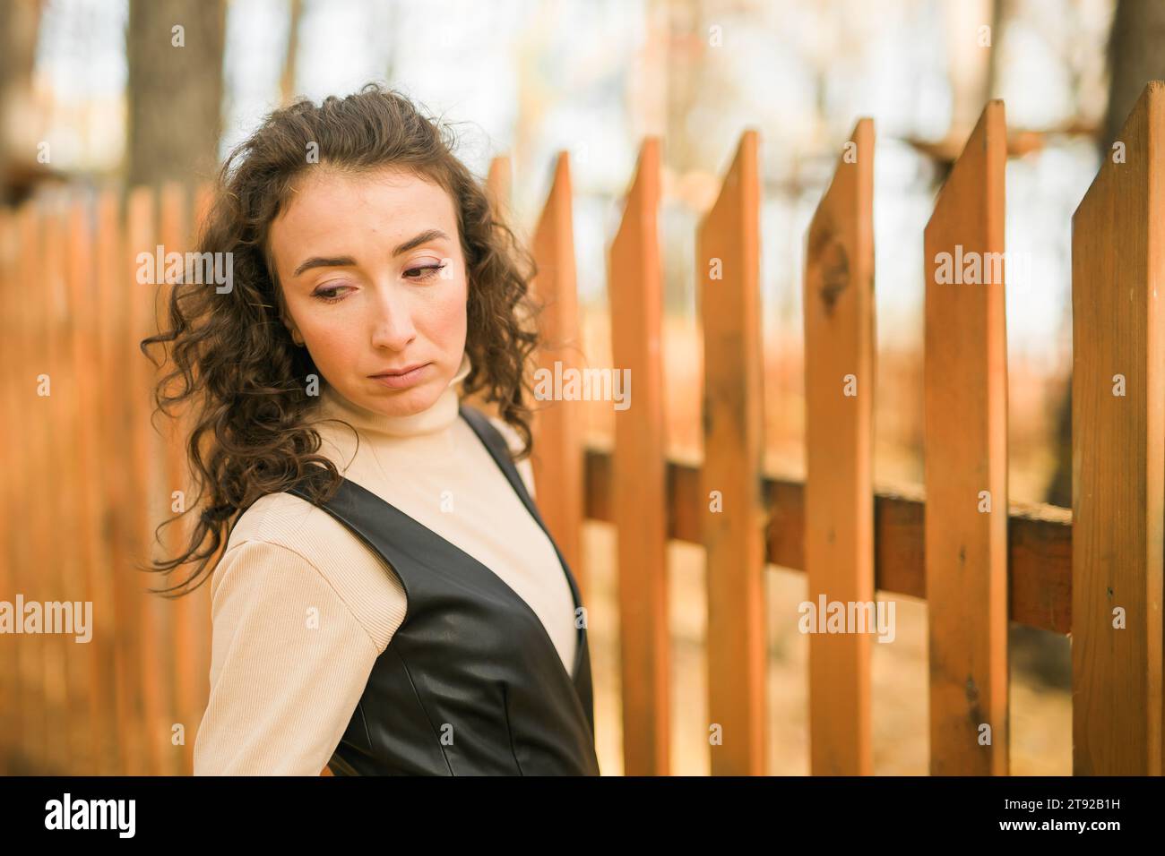 Autumn portrait of a beautiful happy curly woman in fall season copy ...