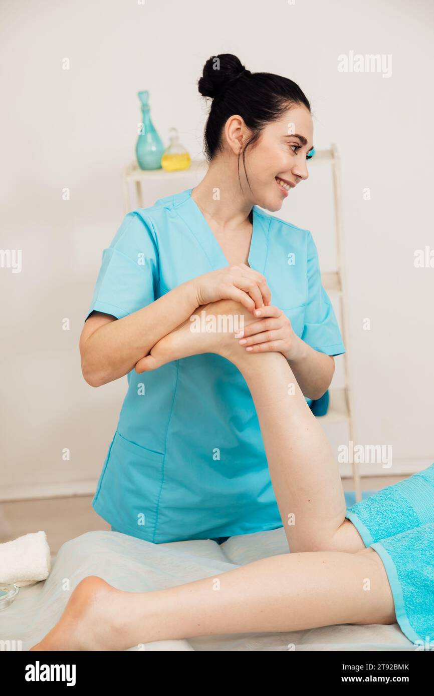 Female masseur doing therapeutic medical foot massage in spa Stock ...
