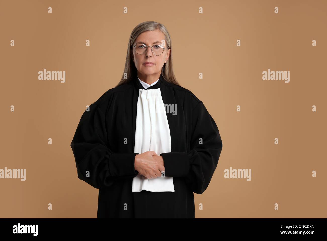Beautiful senior judge in court dress on light brown background Stock ...
