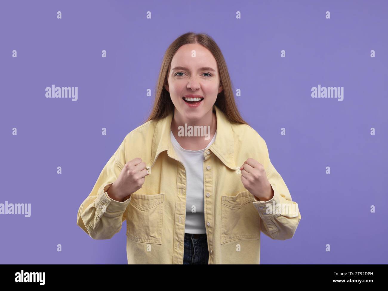 Emotional sports fan celebrating on purple background Stock Photo - Alamy