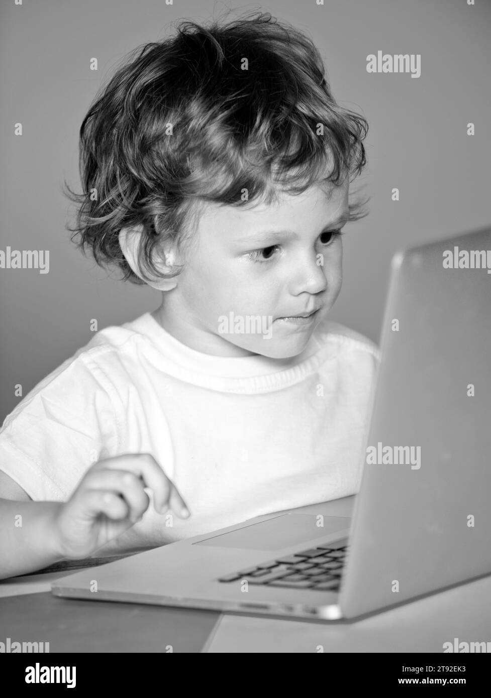 Closeup portrait of clever child boy pupil with laptop. Child from ...