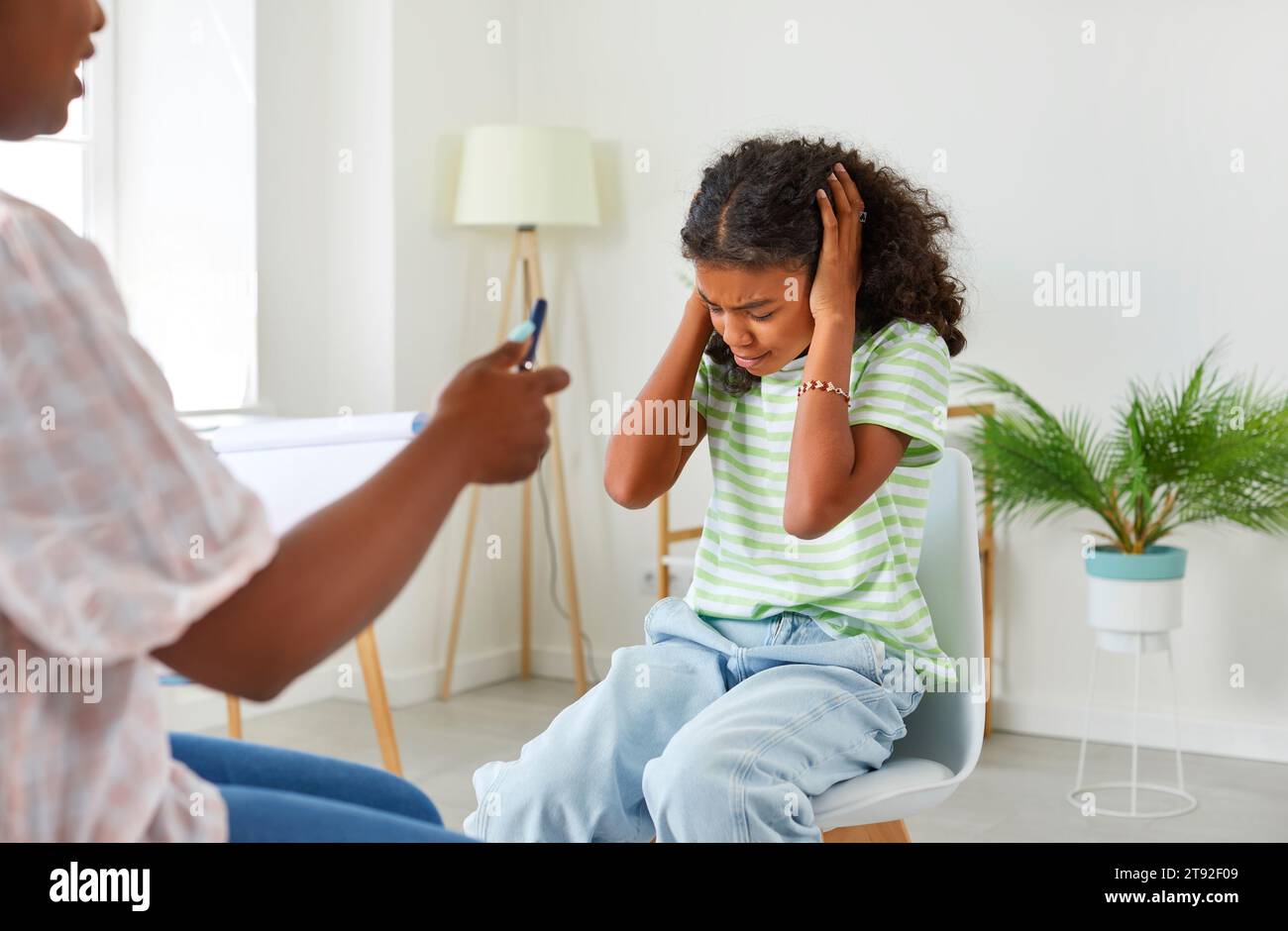 Frustrated confused teen girl closed ears sitting in front of teacher ...