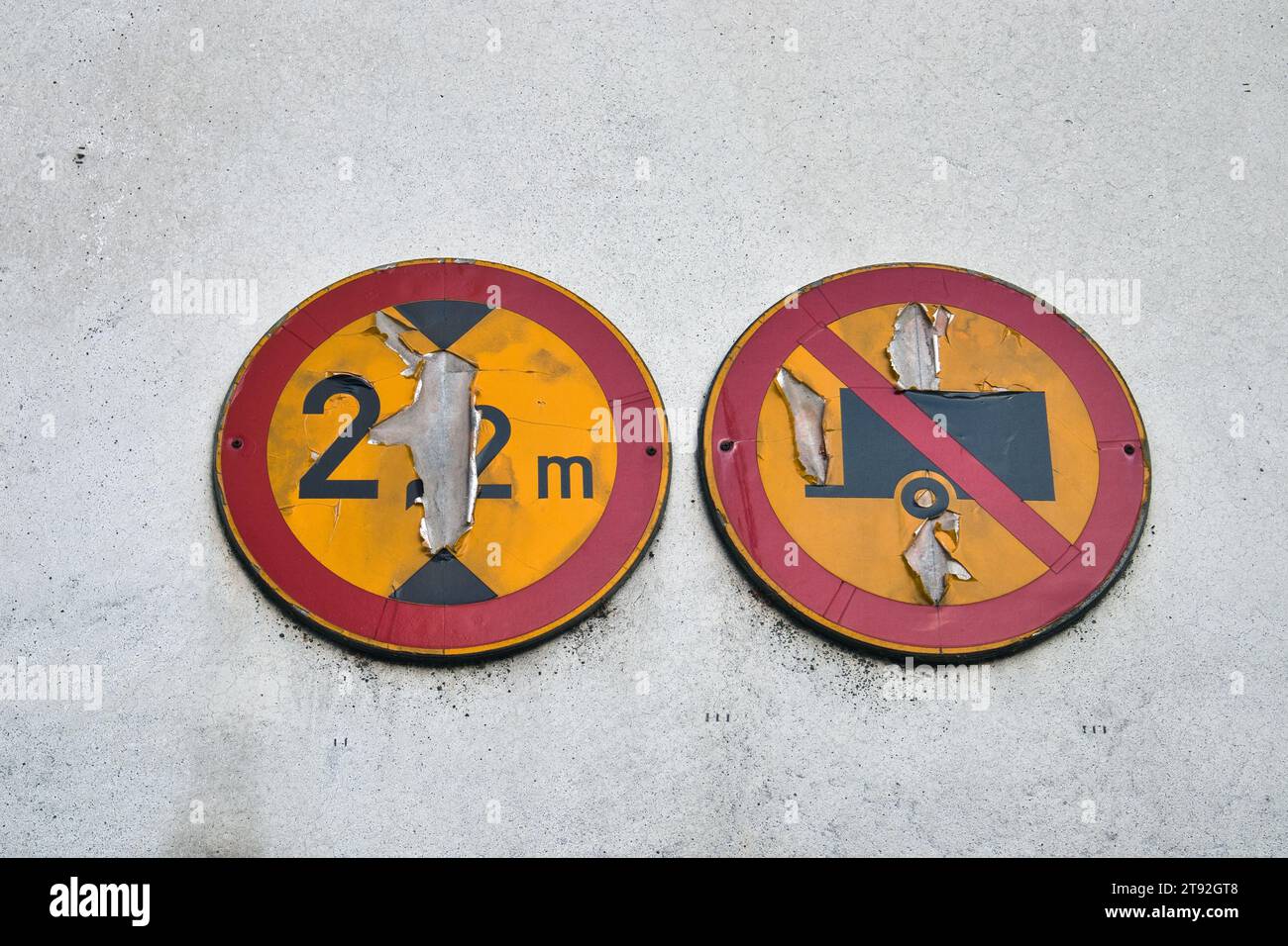 weathered restriction traffic signs on a parking garage wall Stock ...