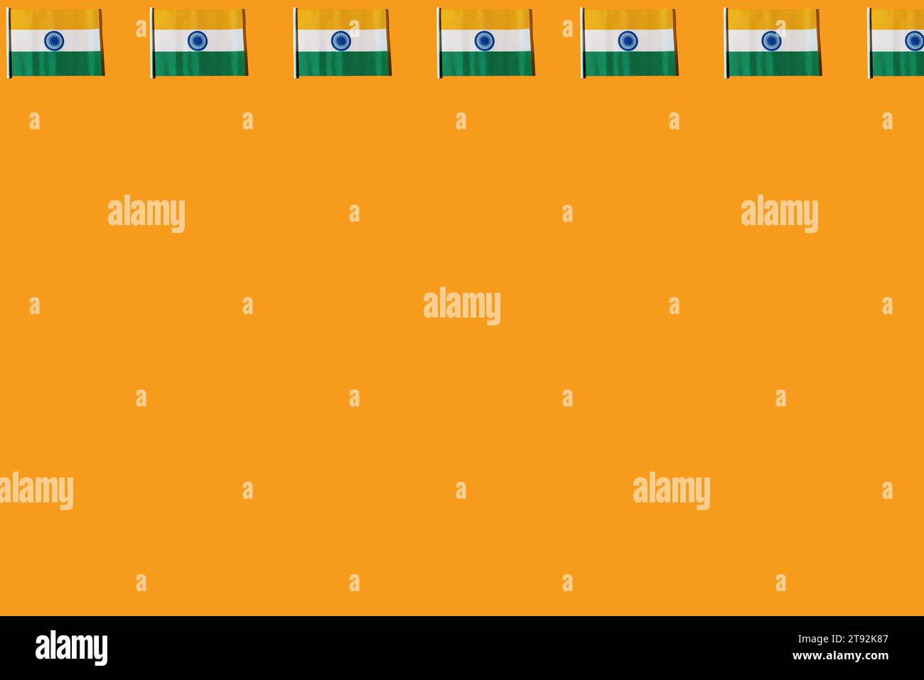 Pattern of flags of the Republic of India, on top, on orange background ...