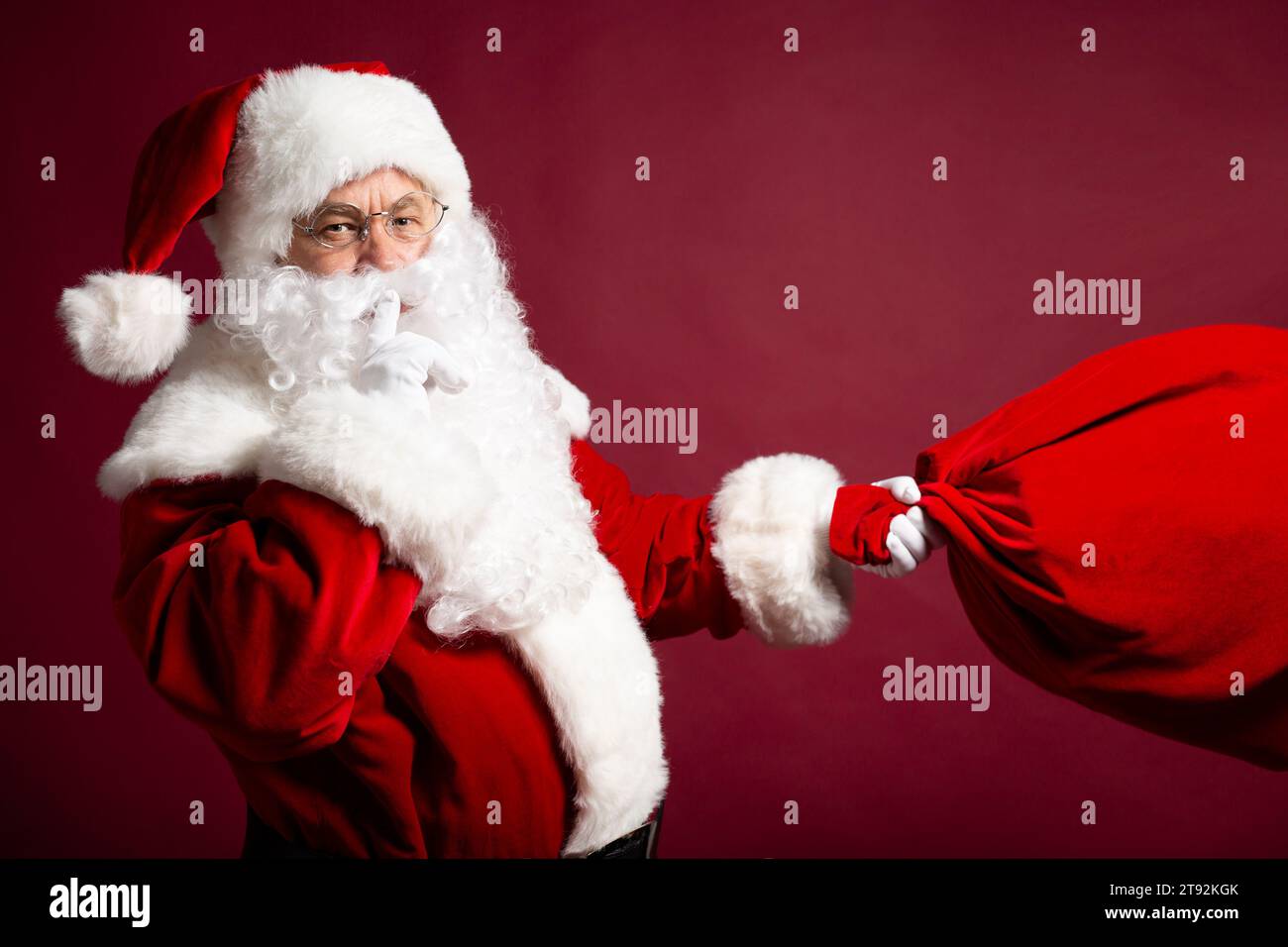 Photo of happy smiling Santa Claus is posing on a red background in ...