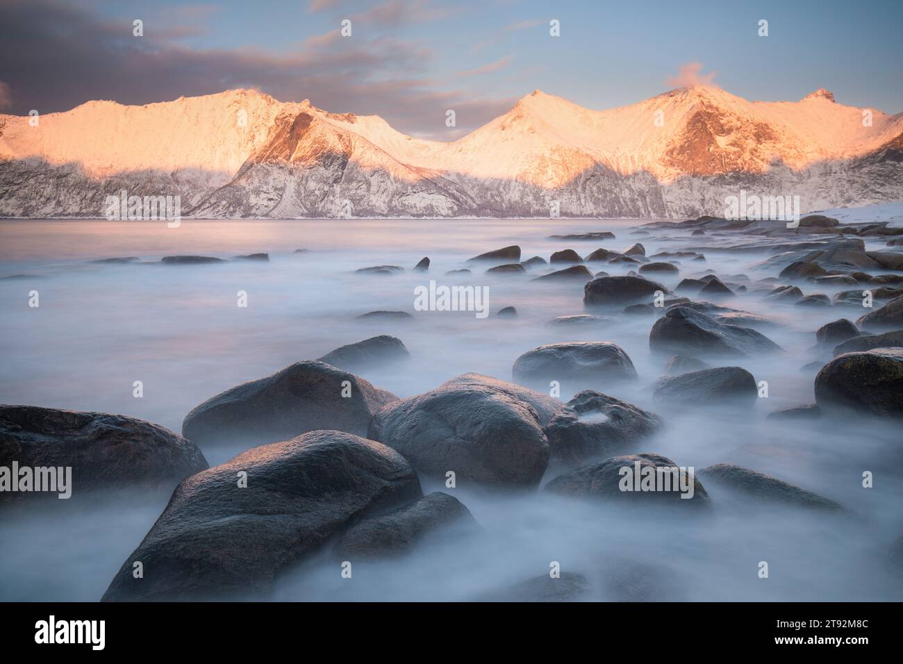 Early morning glow light on snow covered mountains in arctic Norway ...