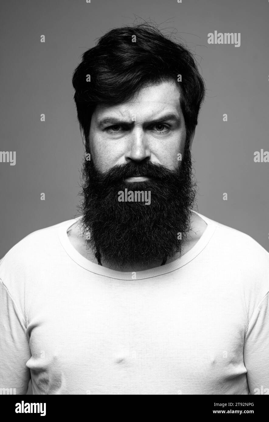 Portrait of confident serious man has beard and mustache, looks ...