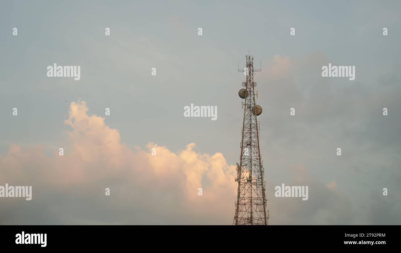Telecommunication tower and the beautiful colors of sunset sky background Stock Photo - Alamy