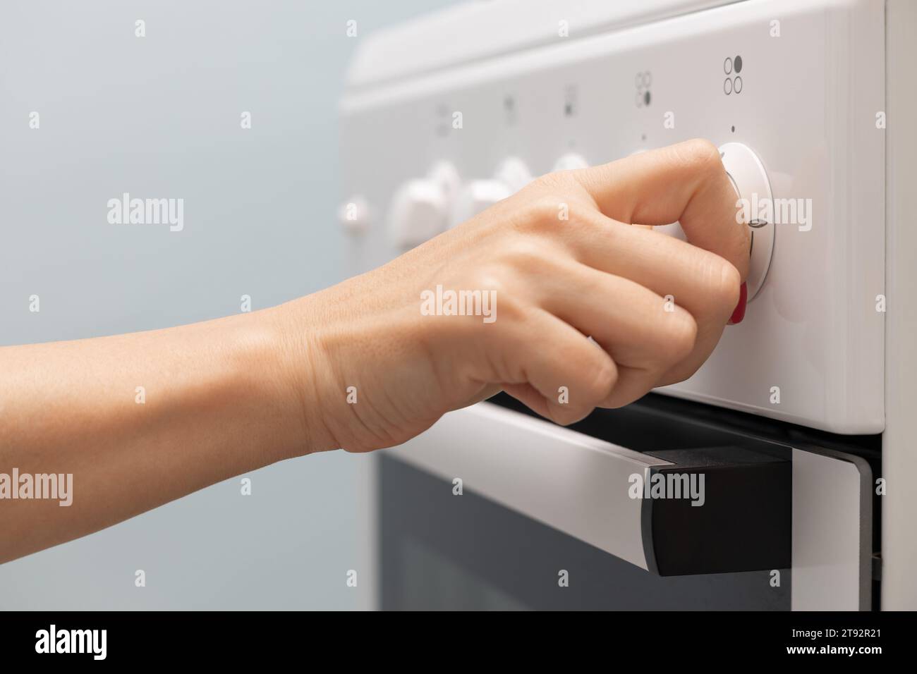 a woman's hand rotates the selector on a gas stove. woman's hand turns ...