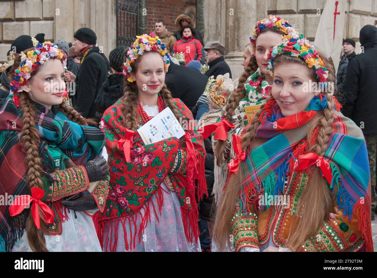 Young women wearing Krakow region costumes and wreaths, getting ready ...