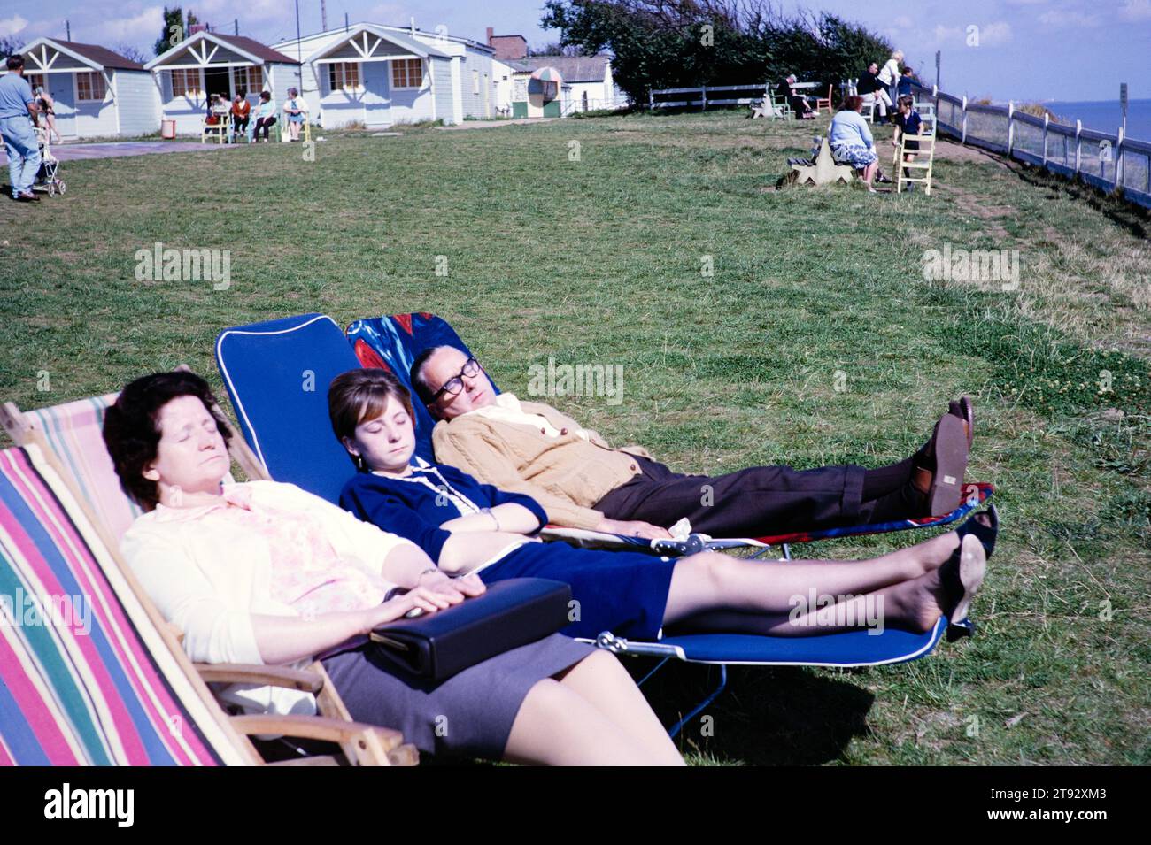 Family in sun loungers deckchairs on summer holiday, thought to be ...