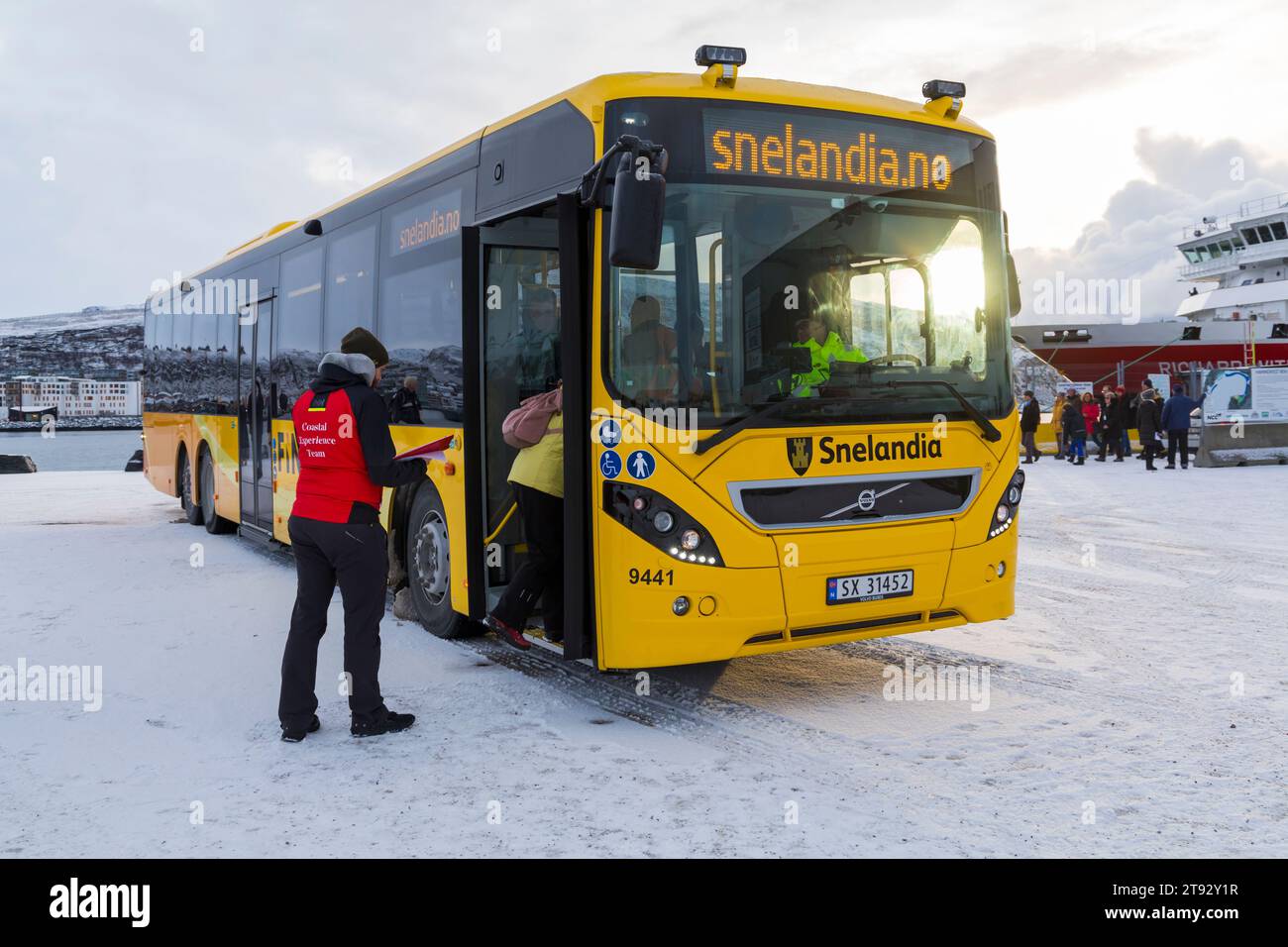 Passengers boarding yellow Snelandia bus at Hammerfest, Norway ...
