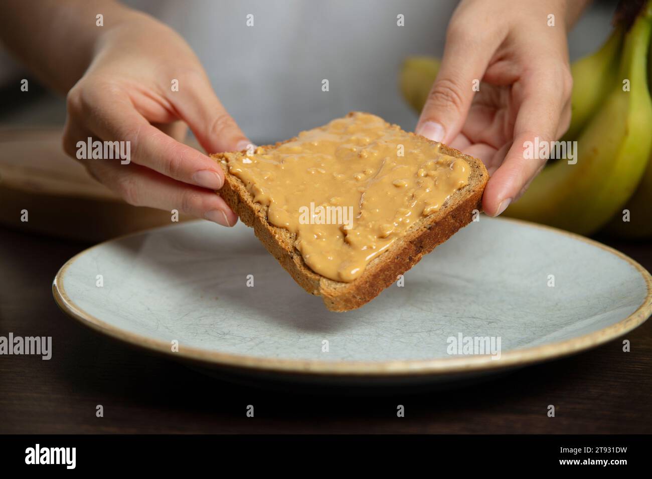Peanut butter sandwich - woman preparing breakfast Stock Photo - Alamy