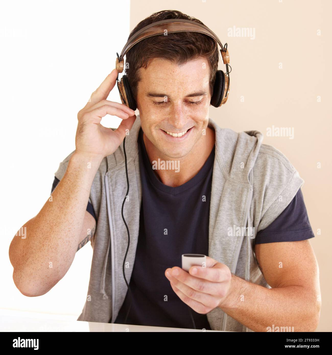 Man, music player and headphones in home for listening to audio ...