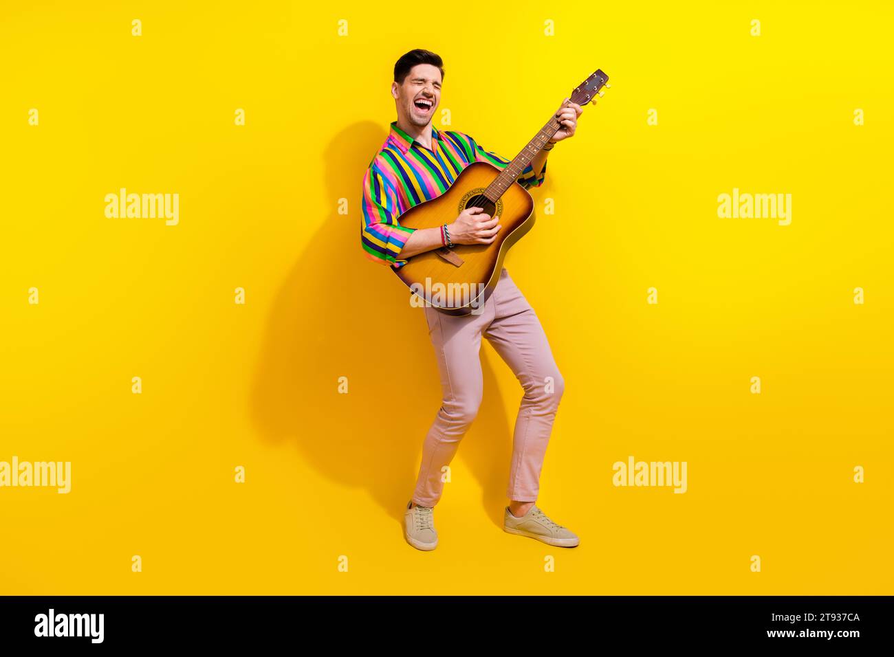 Full body size photo of young model crazy man playing on guitar ...